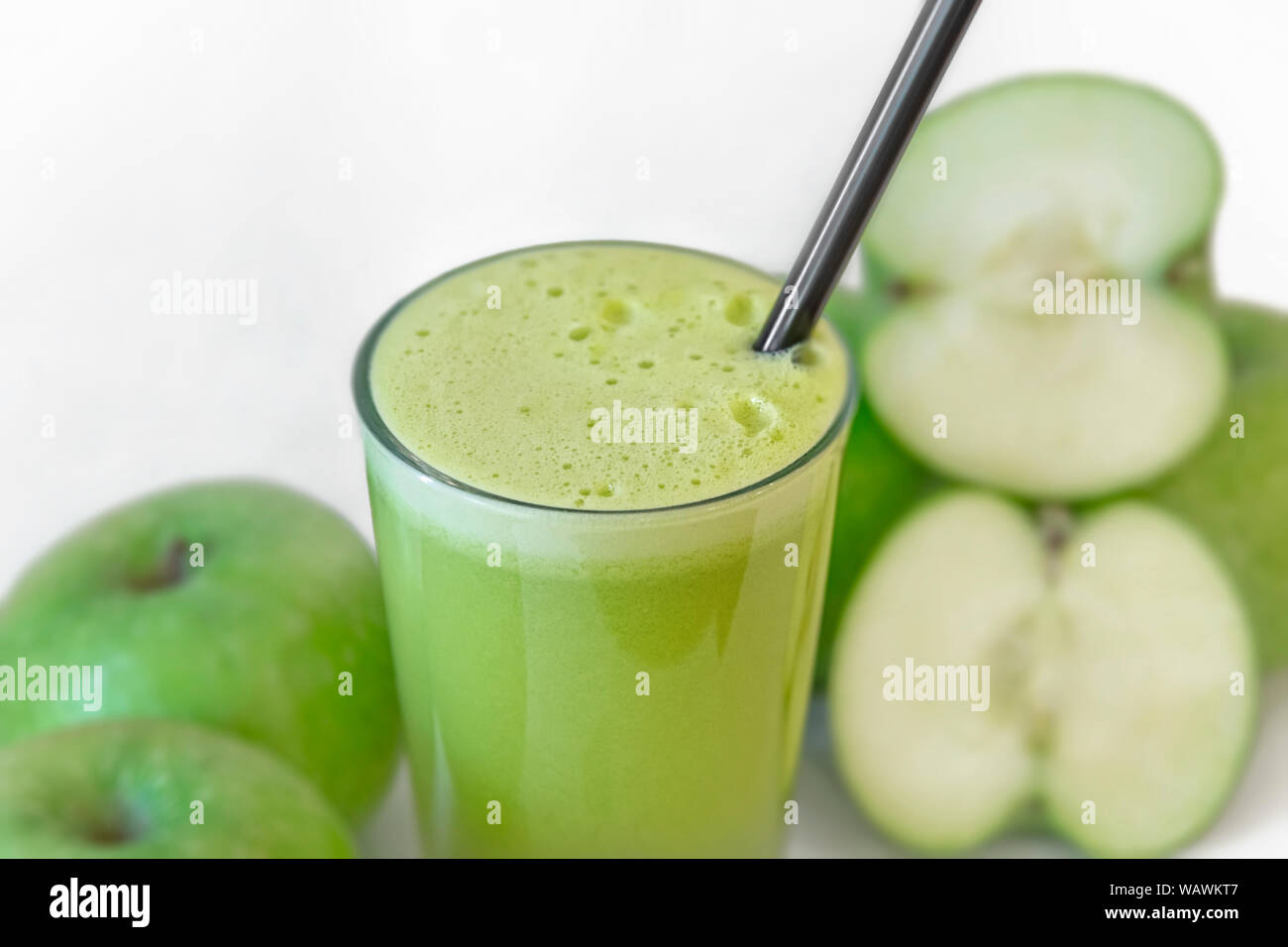 Fresh green apple drink surrounded by green apples Stock Photo - Alamy