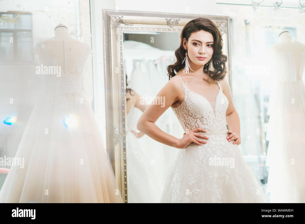 Beautifu bride choosing wedding dress in a wedding salon Stock Photo ...