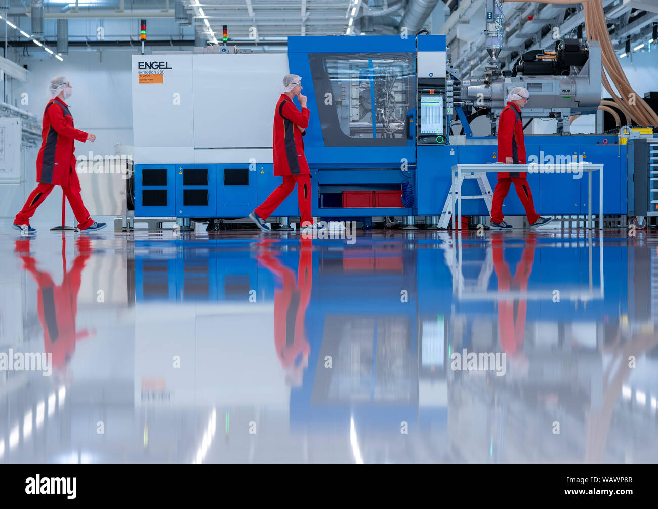Schwerin, Germany. 22nd Aug, 2019. Employees walk past an injection ...
