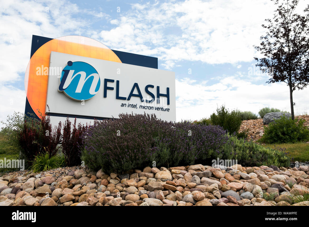 A logo sign outside of the headquarters of IM Flash Technologies in ...