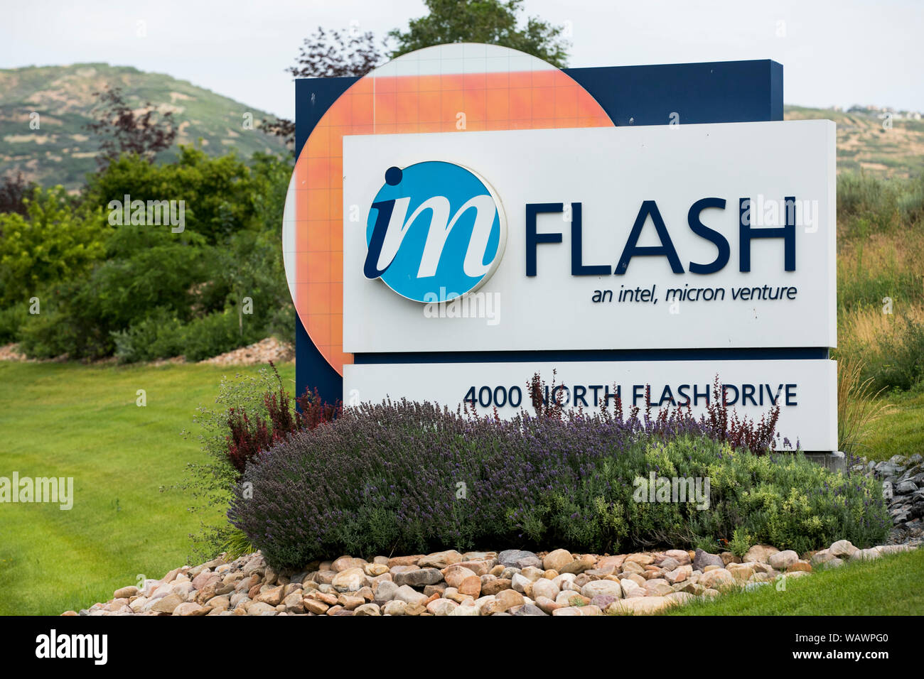 A logo sign outside of the headquarters of IM Flash Technologies in ...