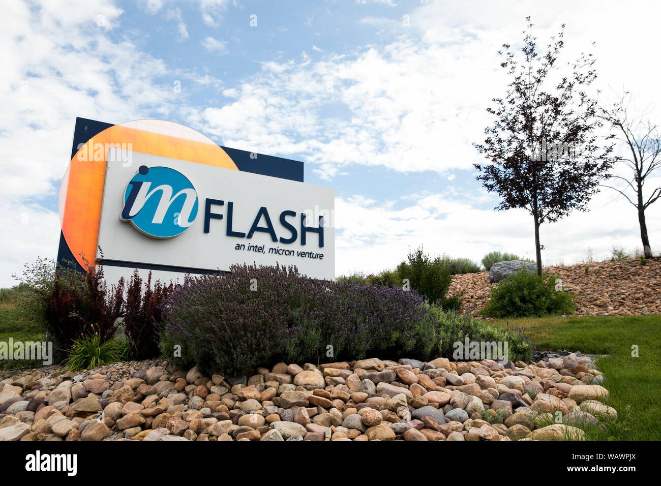 A logo sign outside of the headquarters of IM Flash Technologies in ...