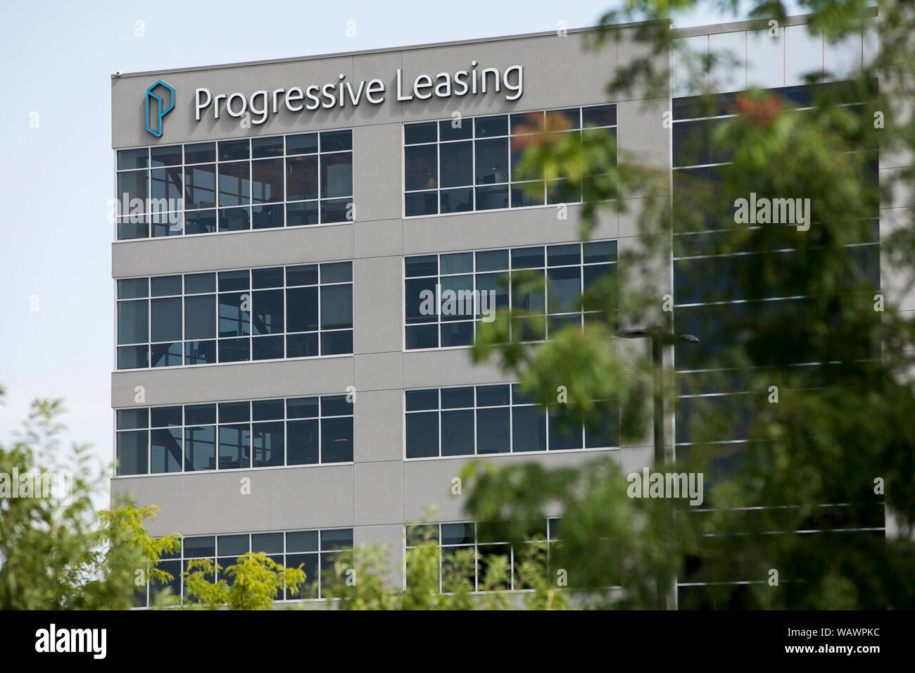 A logo sign outside of the headquarters of Progressive Leasing in ...