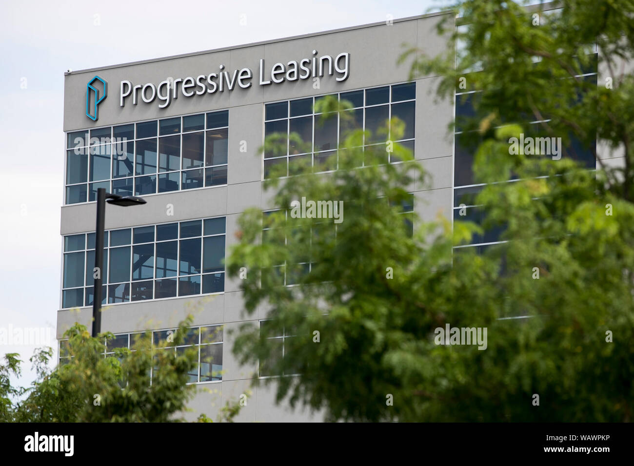 A logo sign outside of the headquarters of Progressive Leasing in ...