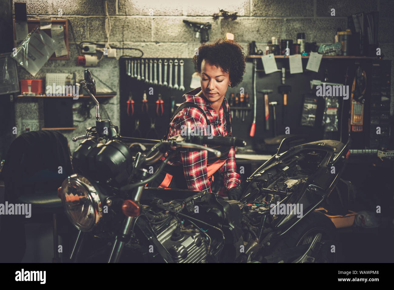 Female biker repairing motorbike engine hi-res stock photography and ...