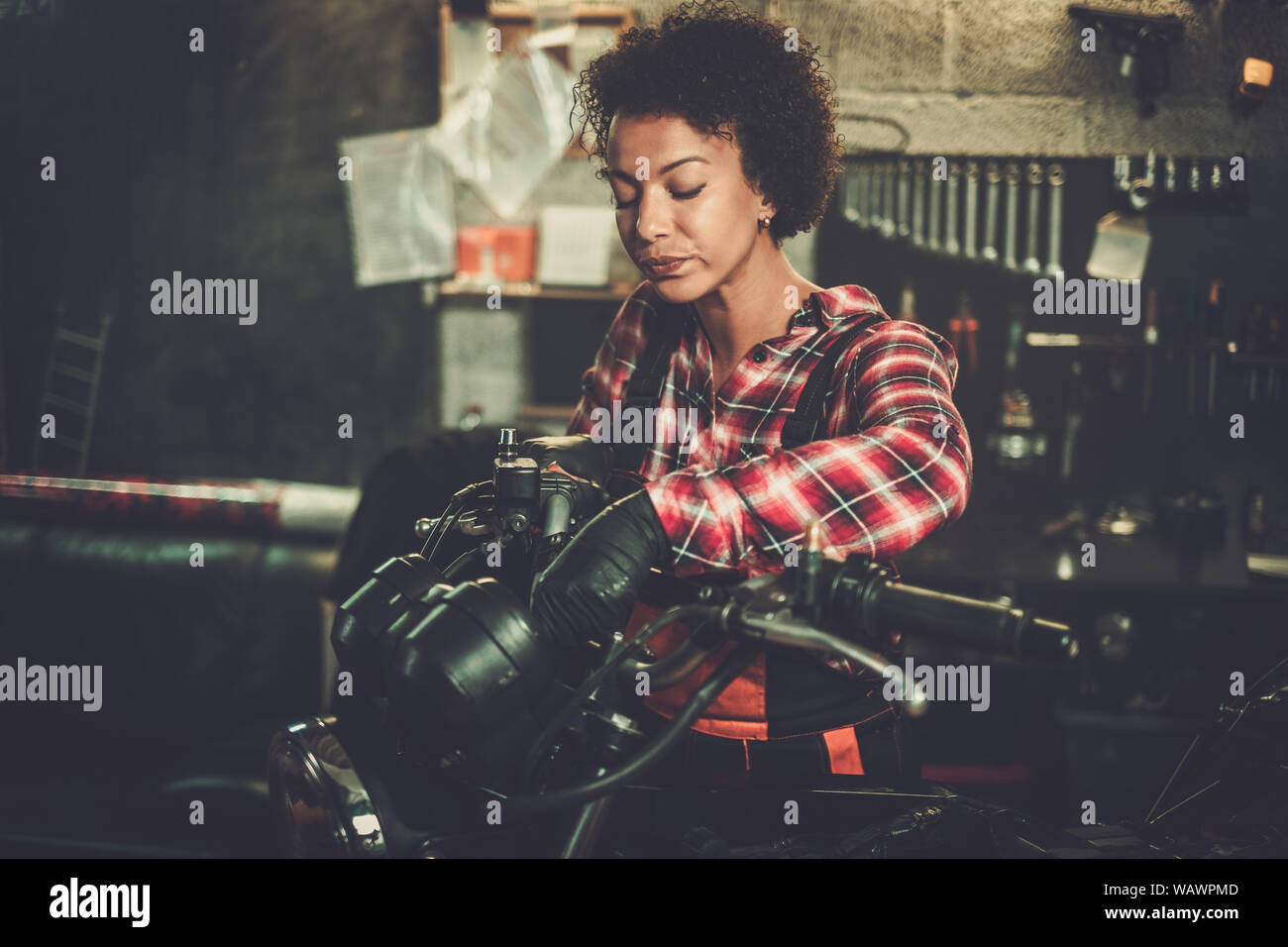 Female biker repairing motorbike engine hi-res stock photography and ...