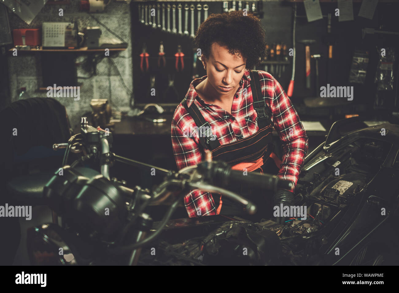 Female biker repairing motorbike engine hi-res stock photography and ...