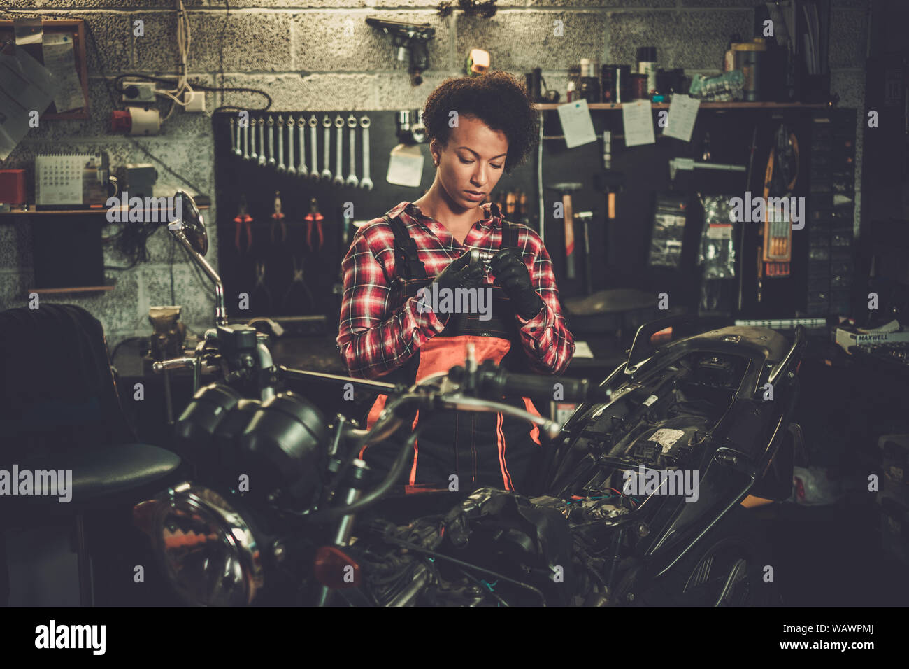 Female biker repairing motorbike engine hi-res stock photography and ...