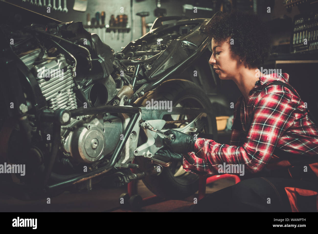 Female biker repairing motorbike engine hi-res stock photography and ...