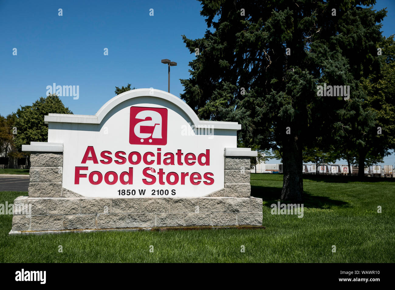 A logo sign outside of the headquarters of Associated Food Stores in ...