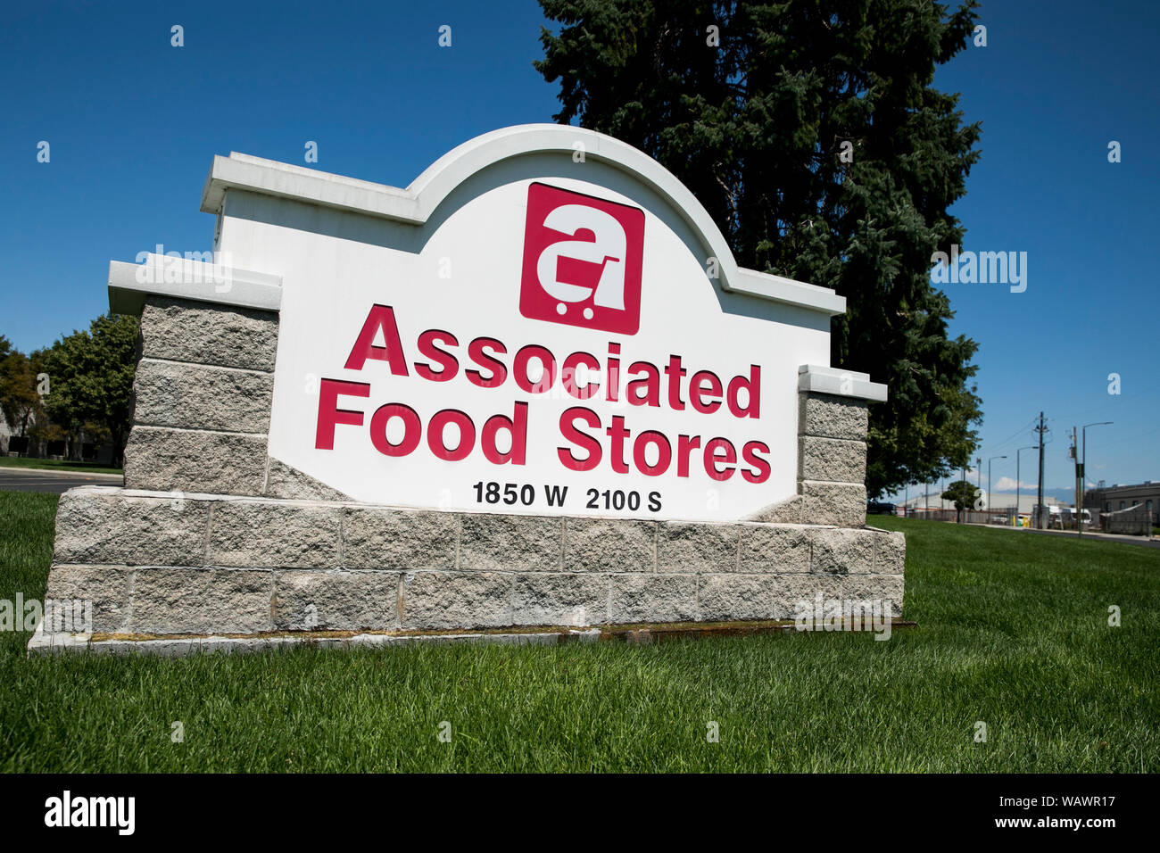 A logo sign outside of the headquarters of Associated Food Stores in ...