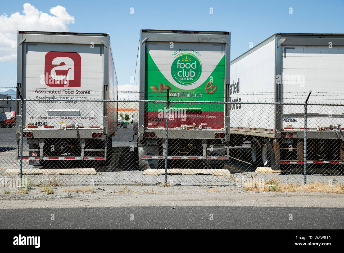 A logo sign outside of the headquarters of Associated Food Stores in ...