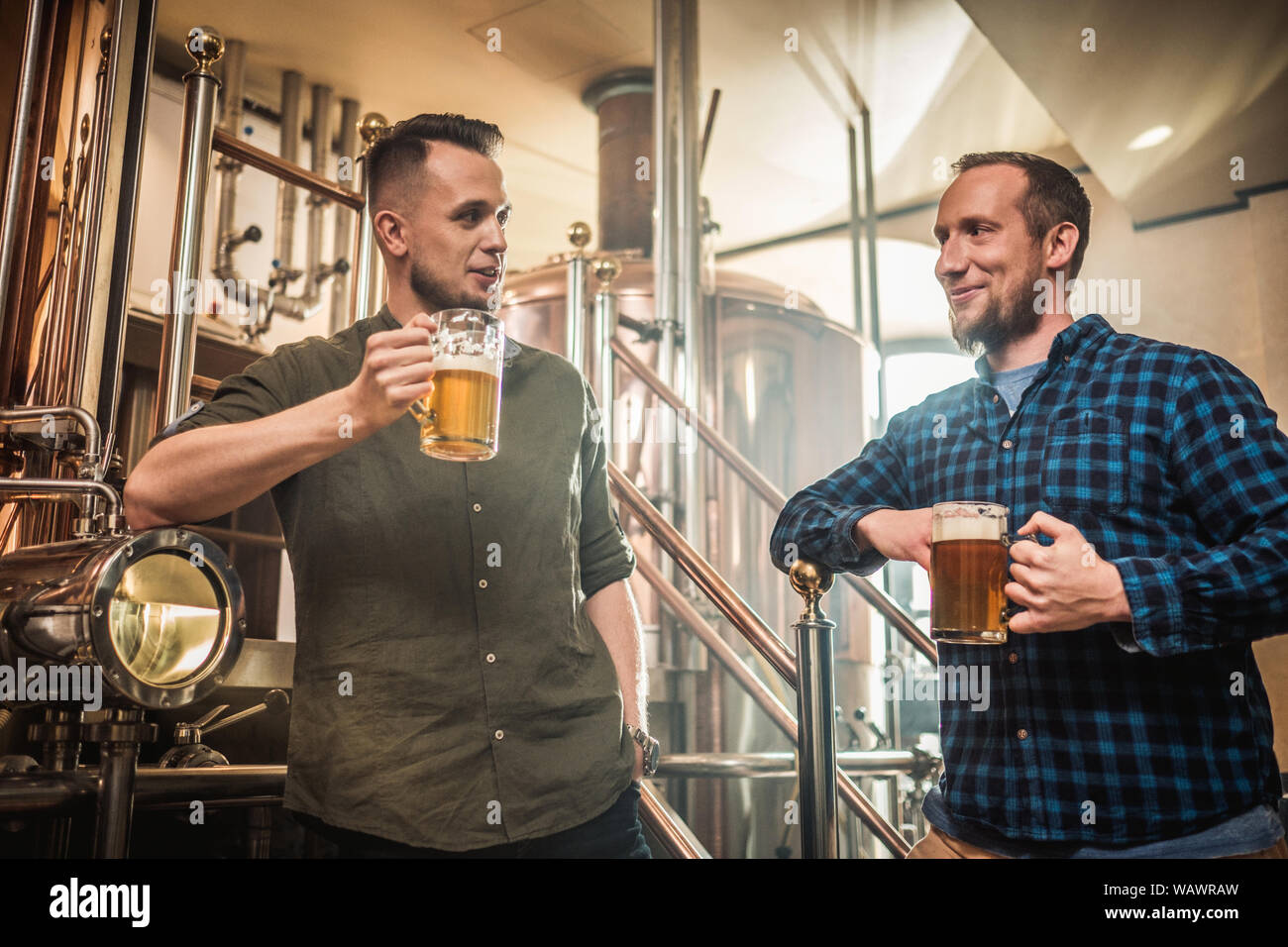 Two men tasting fresh beer in a brewery Stock Photo - Alamy