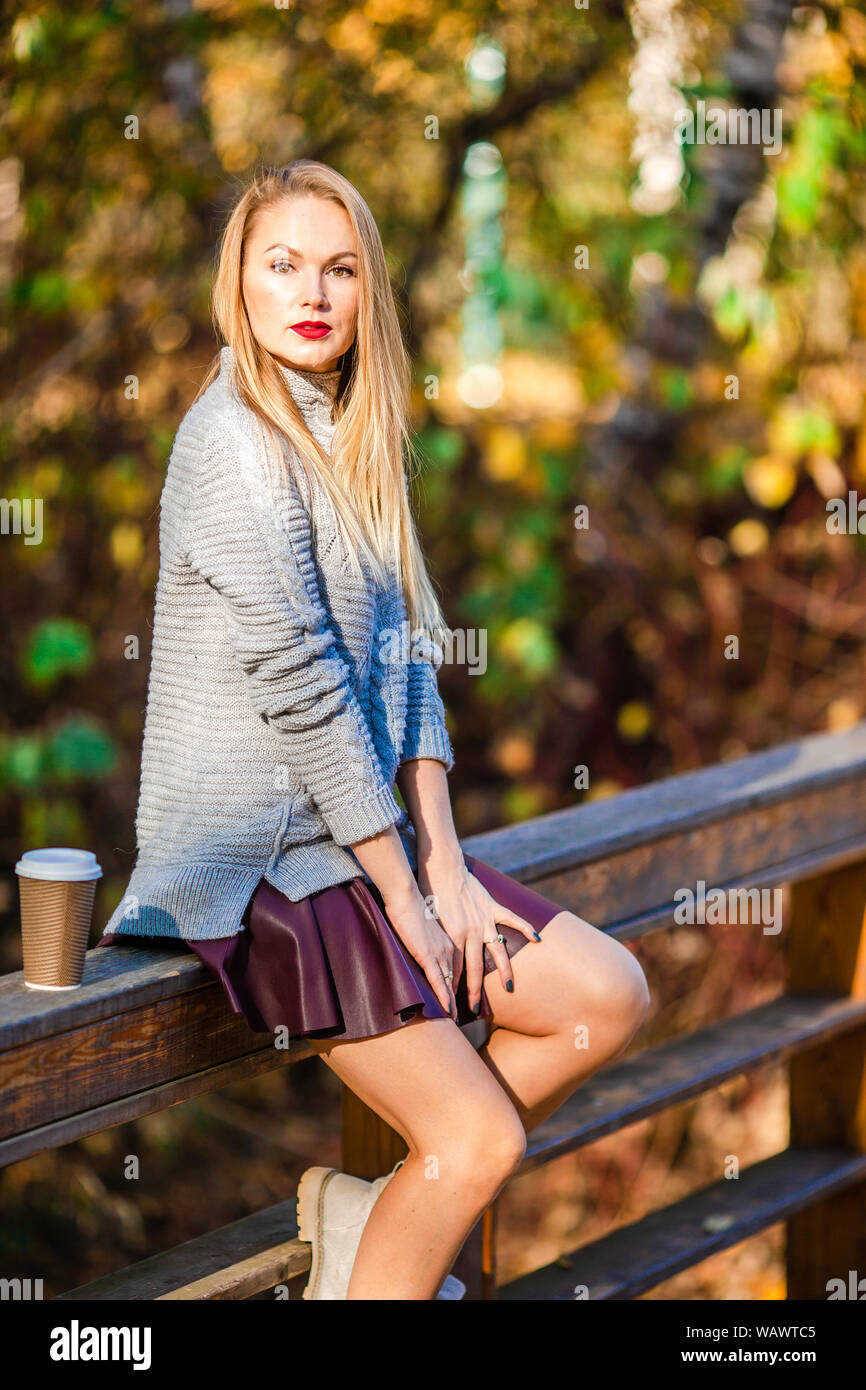 Beautiful woman in autumn park under fall foliage at warm day Stock ...