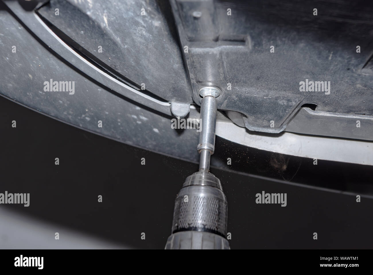 Mechanic at work. Attach a screw with the cordless screwdriver Stock ...