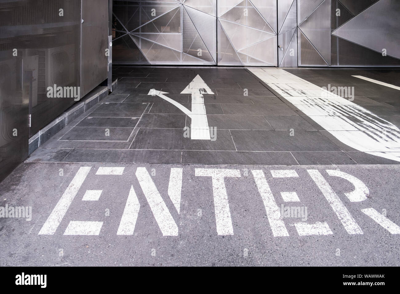 Enter text with two arrows painted on the floor of an underground ...
