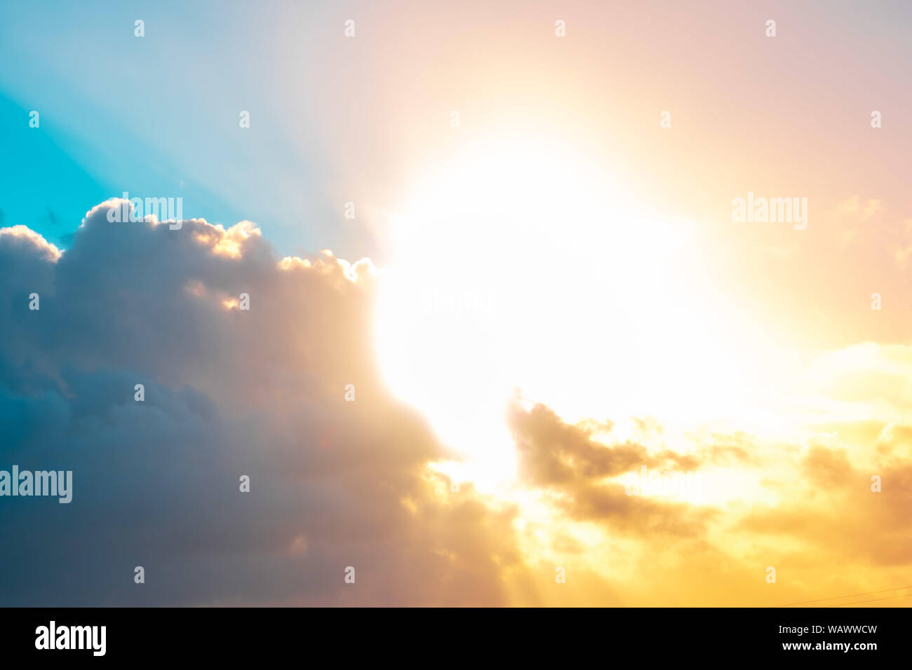 Bright sunshine through storm clouds at sunset - colorful background ...