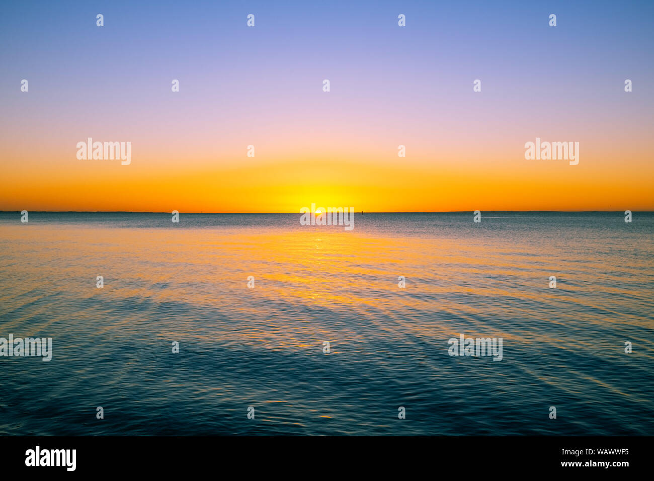 Vivid beautiful sunset - sun almost disappeard behind the horizon over ...