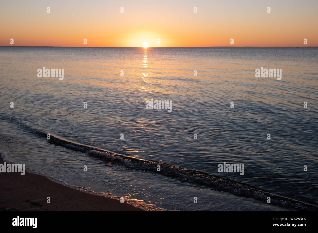 Calm bay waters at golden sunset - minimal landscape with copy space ...