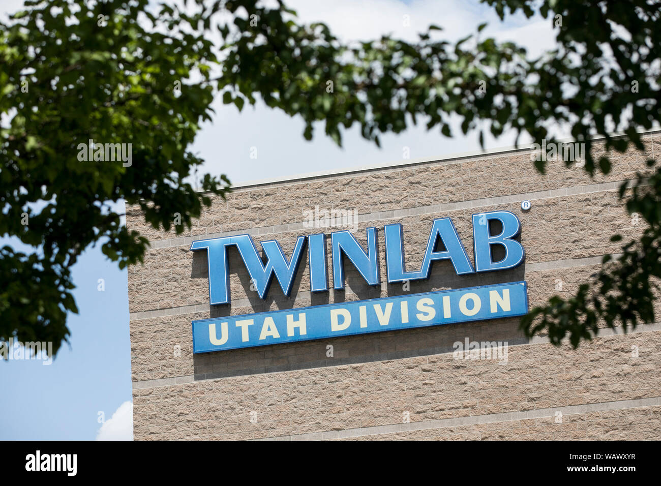 A logo sign outside of a facility occupied by the Twinlab Corporation ...