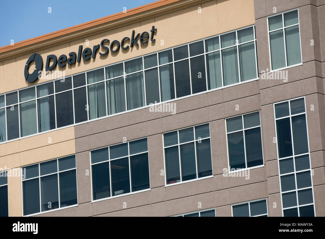 A logo sign outside of a facility occupied by DealerSocket in Draper ...