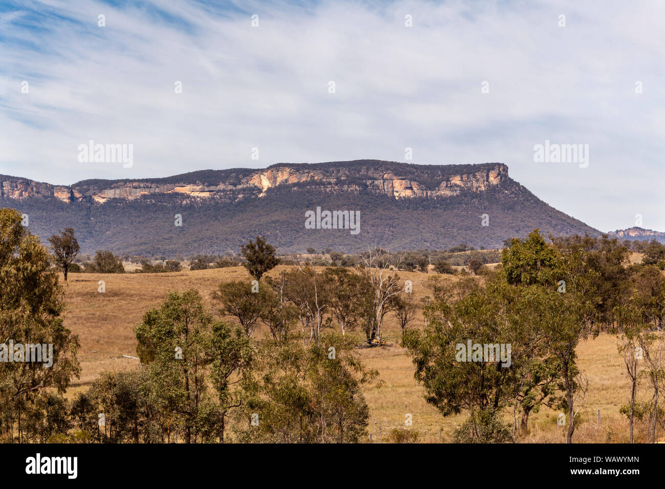 Grassy plains backed by sandstone ridges in the Capertee Valley, NSW ...