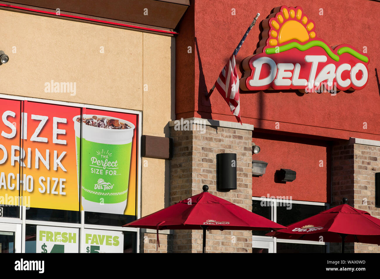 A logo sign outside of a Del Taco fast food restaurant location in Lehi ...
