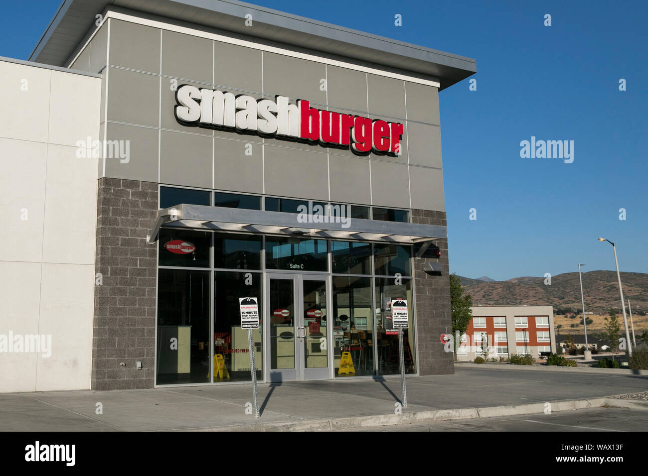 A logo sign outside of a Smashburger restaurant location in Lehi, Utah ...