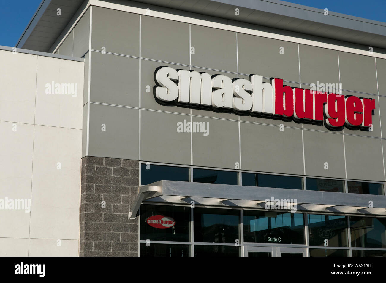 A logo sign outside of a Smashburger restaurant location in Lehi, Utah ...