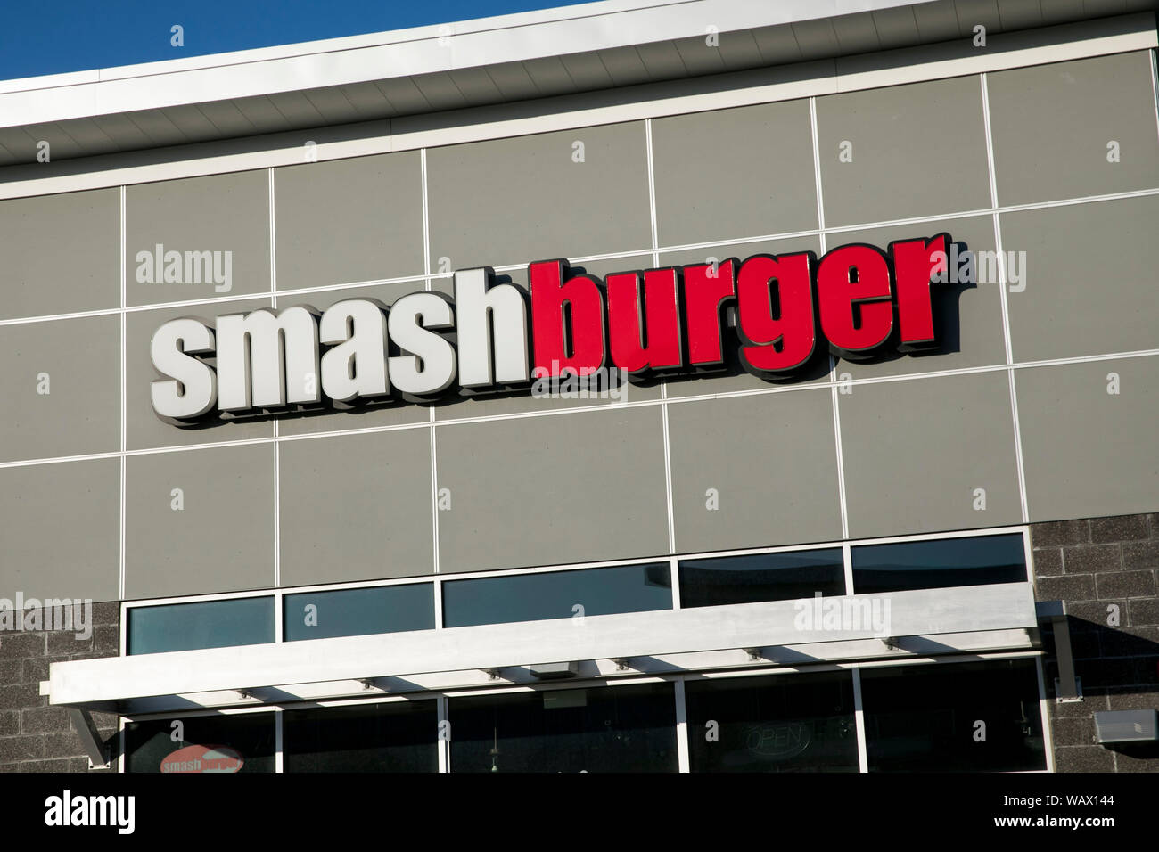 A logo sign outside of a Smashburger restaurant location in Lehi, Utah ...