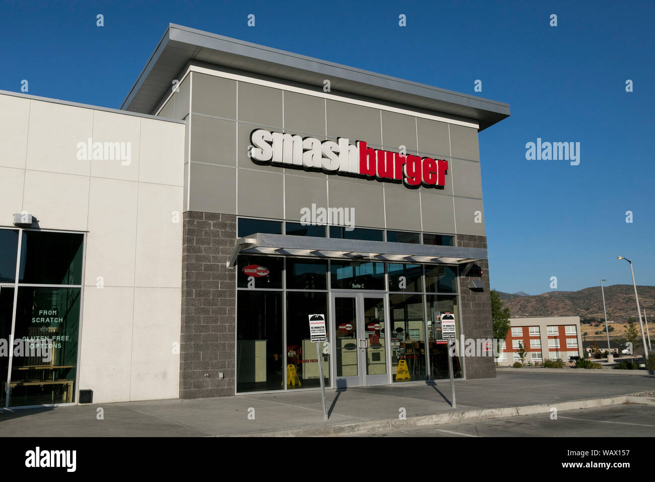A logo sign outside of a Smashburger restaurant location in Lehi, Utah ...