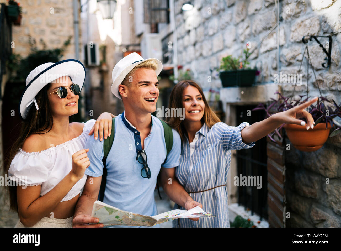 Happy group of friends tourists sightseeing in city on vacation Stock ...