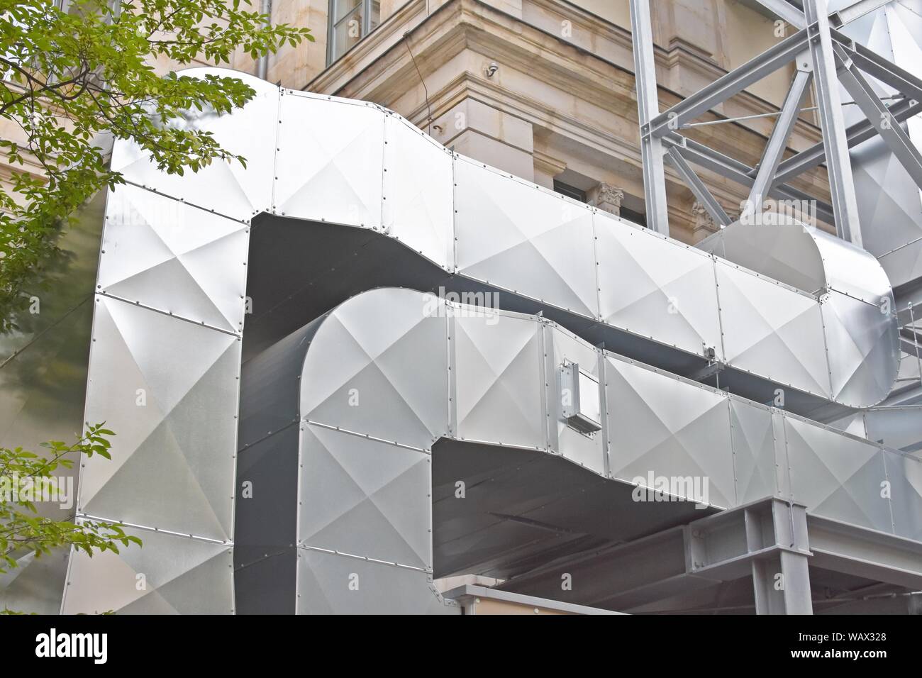 Modern metal tubing along the old architecture building Stock Photo - Alamy