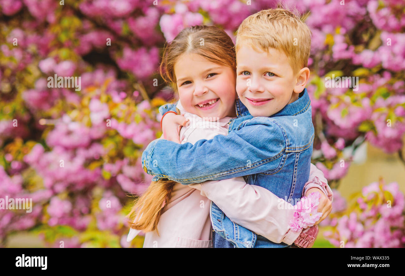 Love is in the air. Romantic babies. Couple kids walk sakura tree ...