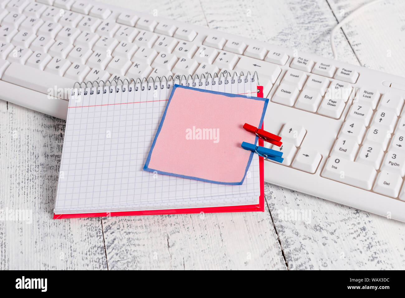 notebook paper reminder clothespin pinned sheet white keyboard light ...