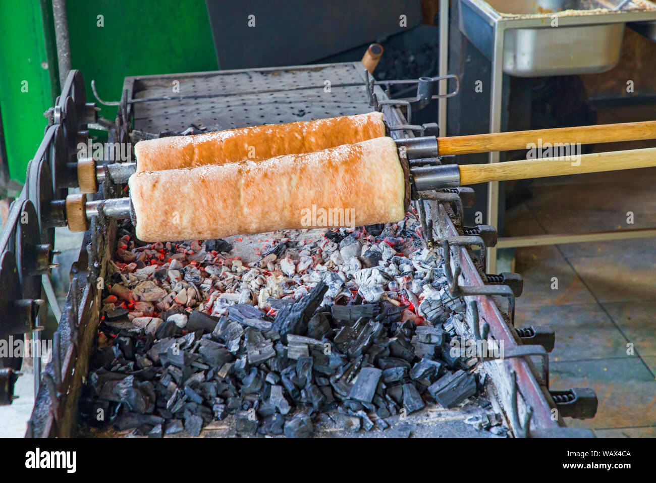 Close image of baking kurtos kalacs on grill, hungarian food Stock ...