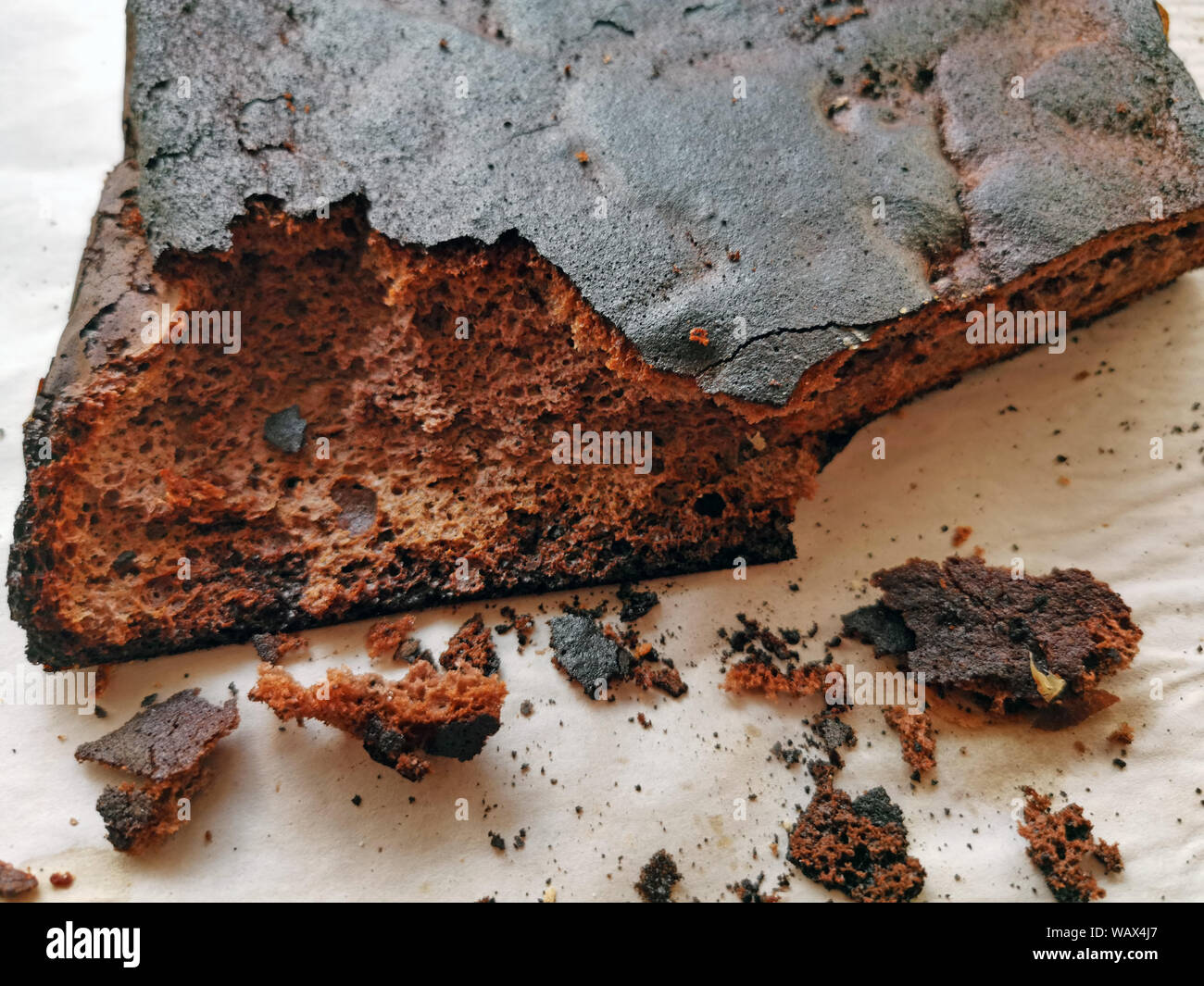 Cooking failure, burnt pie with black crust on baking paper Stock Photo ...