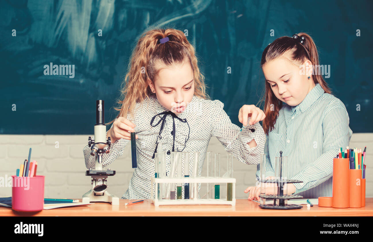 Really busy. students doing biology experiments with microscope. Little ...