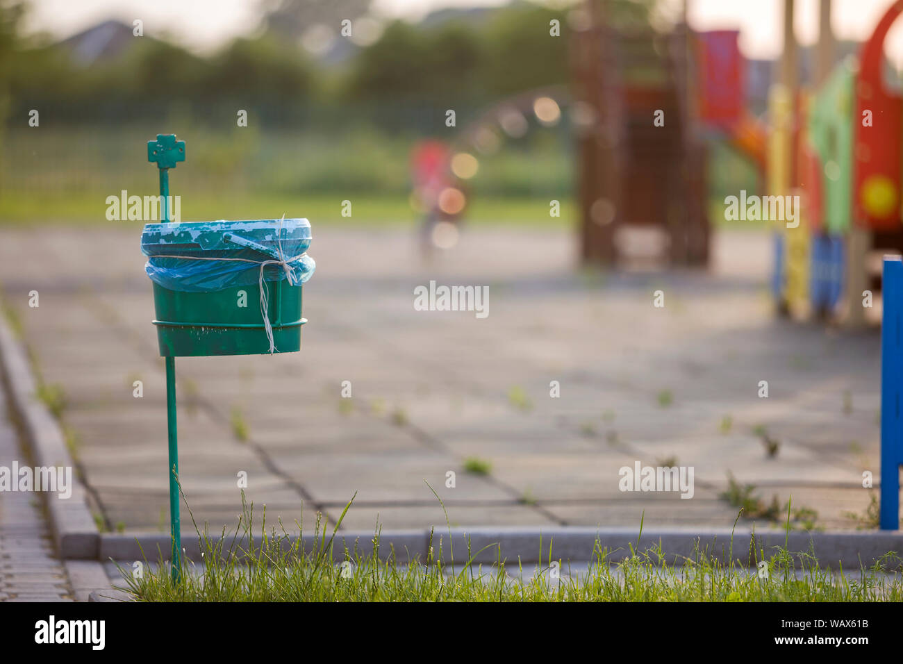 Garbage bin outdoor on blurred sunny background Stock Photo - Alamy