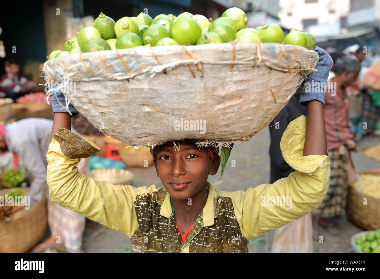 Young porter in the market at the Buriganga River in Old Dhaka ...
