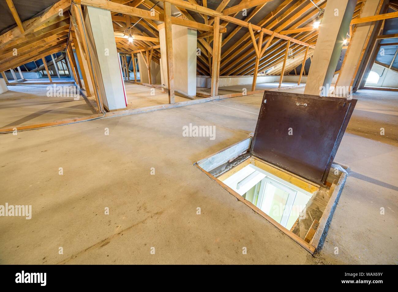 Attic of a building with wooden beams of a roof structure and a fire ...