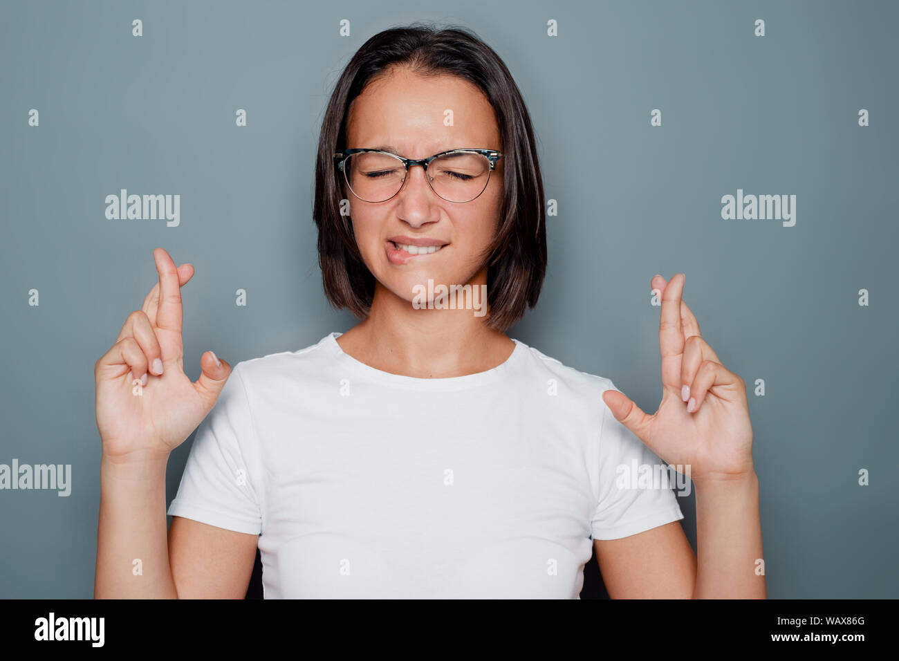 Fingers crossed woman hi-res stock photography and images - Alamy