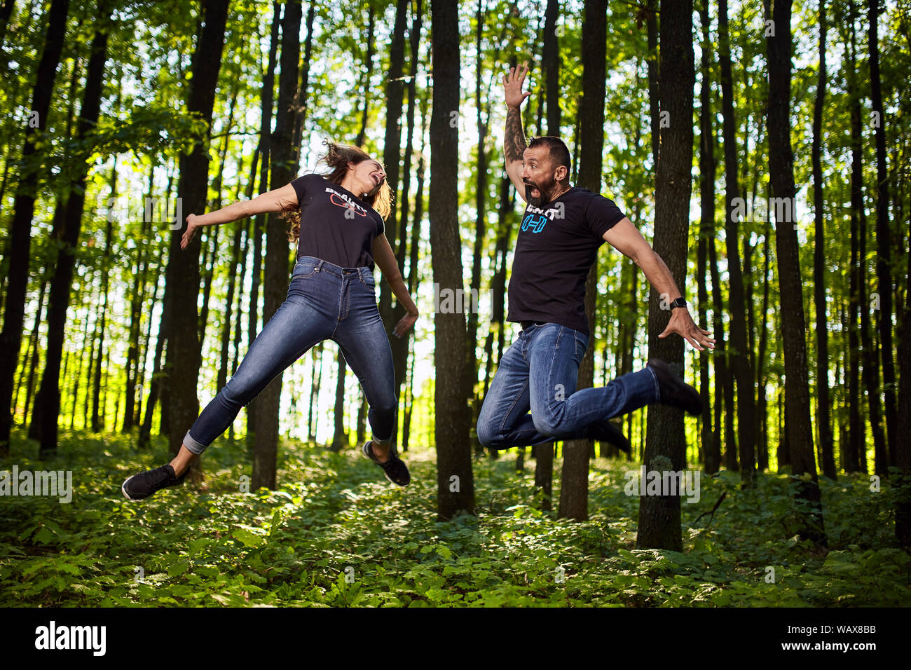 Funny couple jumping for joy Stock Photo - Alamy