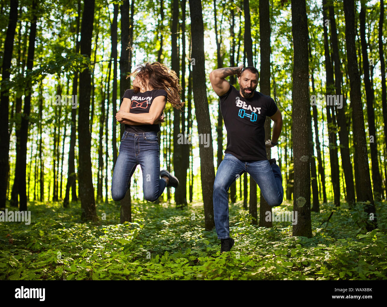 Funny couple jumping for joy Stock Photo - Alamy