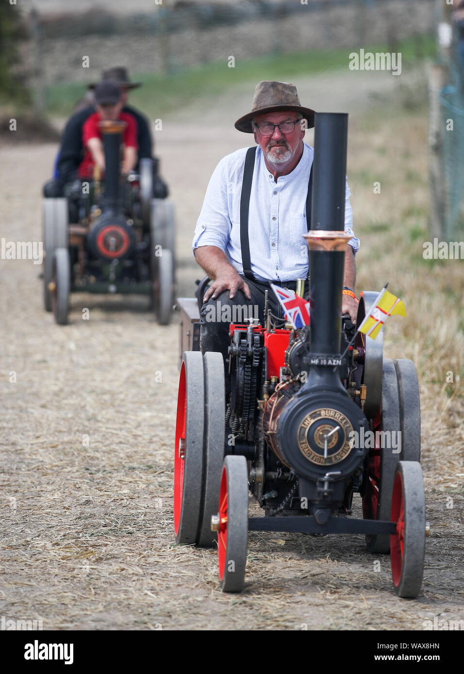 A steam enthusiast drives his miniature steam engine out of the main ...