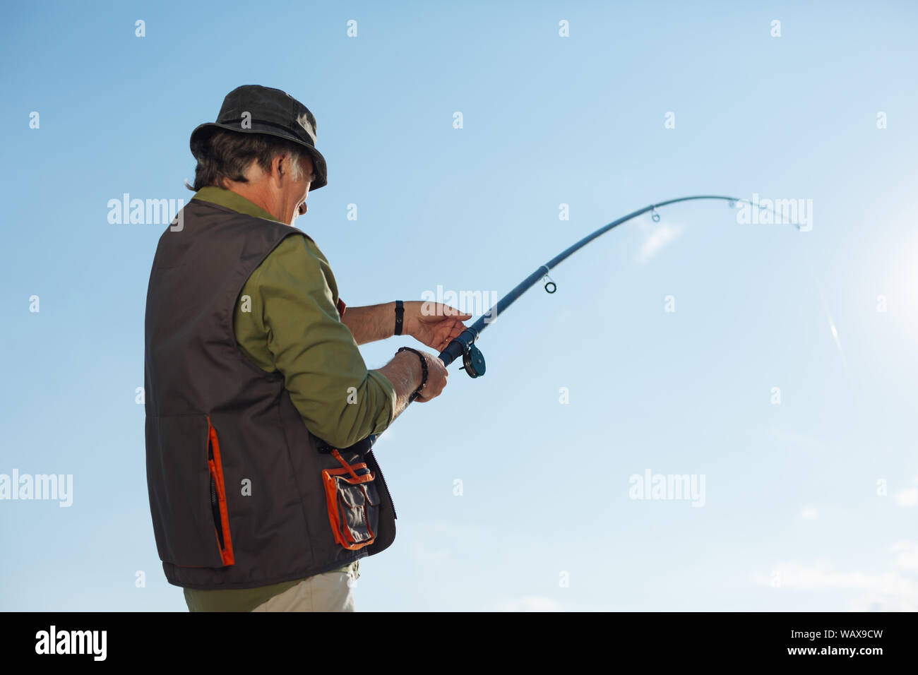 Man pulling fishing tackle hi-res stock photography and images - Alamy