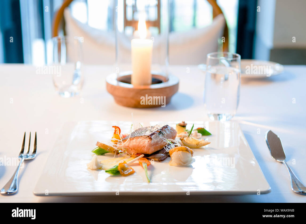Grilled fish with grilled vegetables dish on dinner table Stock Photo ...