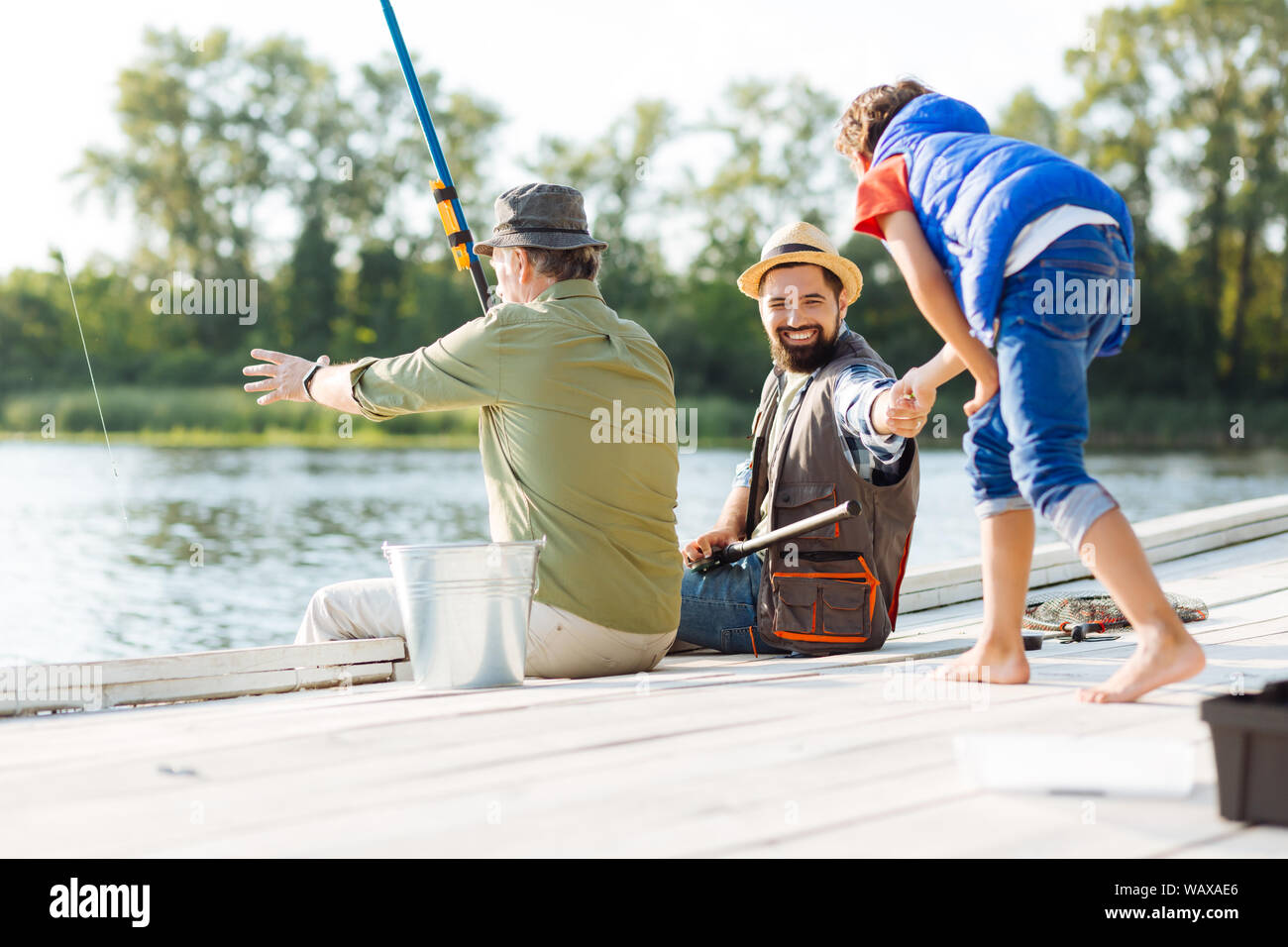 Men feeling happy while having family fishing Stock Photo - Alamy