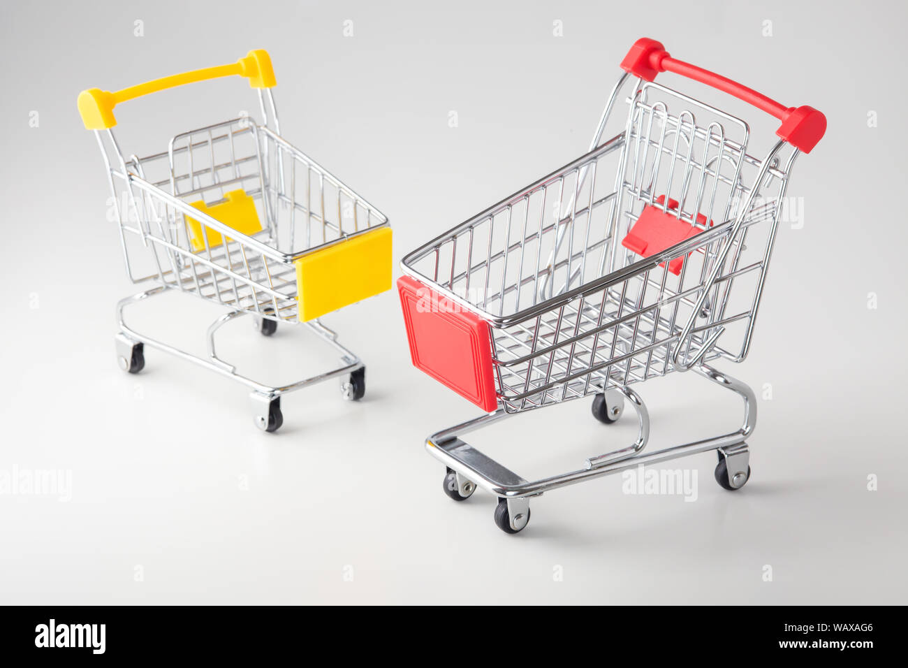 Shopping trolleys, red and yellow on white background Stock Photo - Alamy