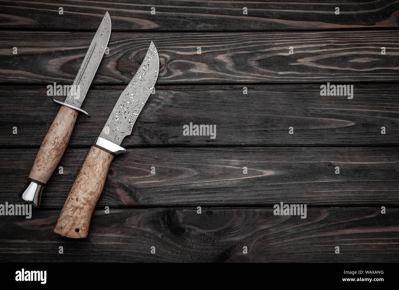 Hunting bowie knife with a wooden handle on dark wooden background ...